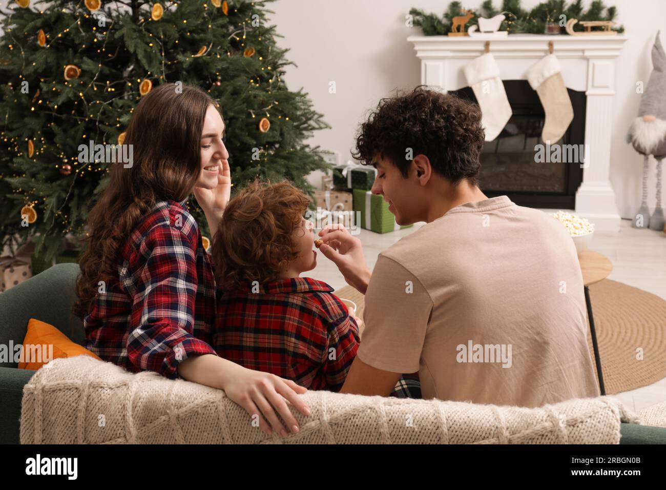 Family with popcorn spending time together at home Stock Photo - Alamy