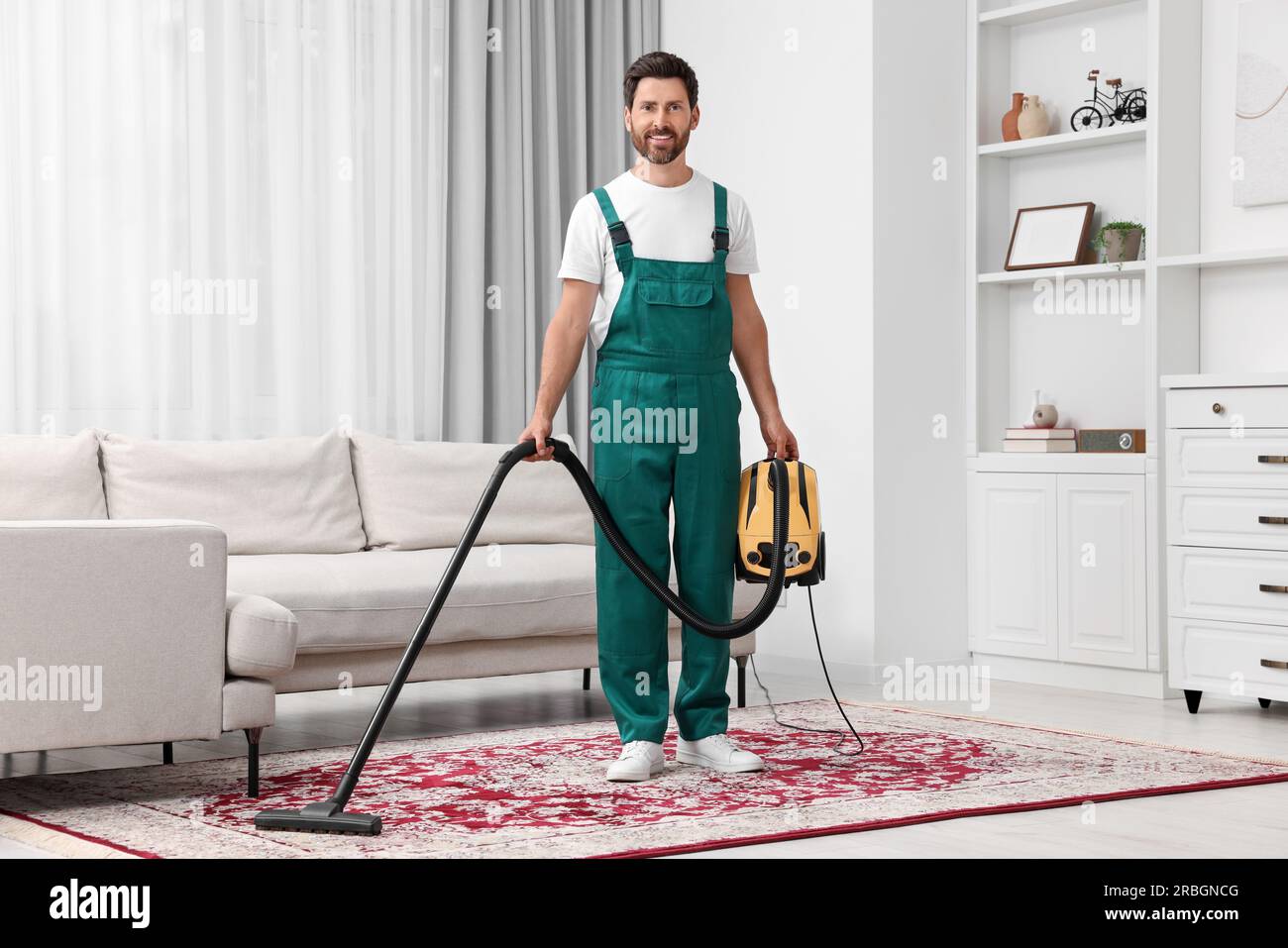 Dry cleaners employee hoovering hi-res stock photography and images - Alamy