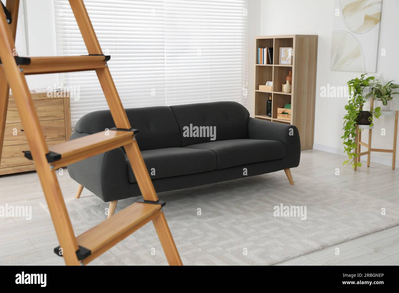 Wooden folding ladder in stylish living room Stock Photo - Alamy
