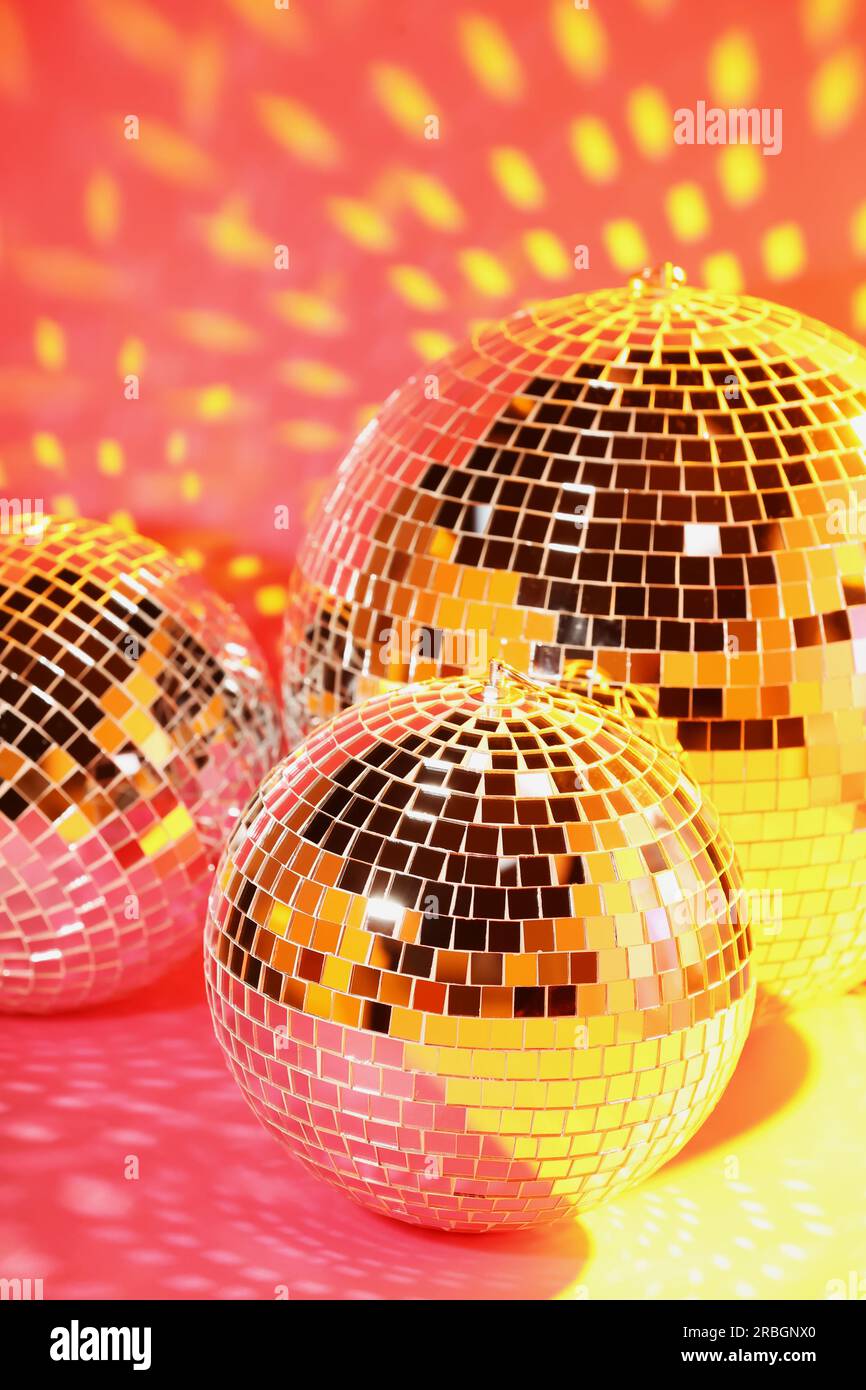 Many shiny disco balls on pink background Stock Photo - Alamy