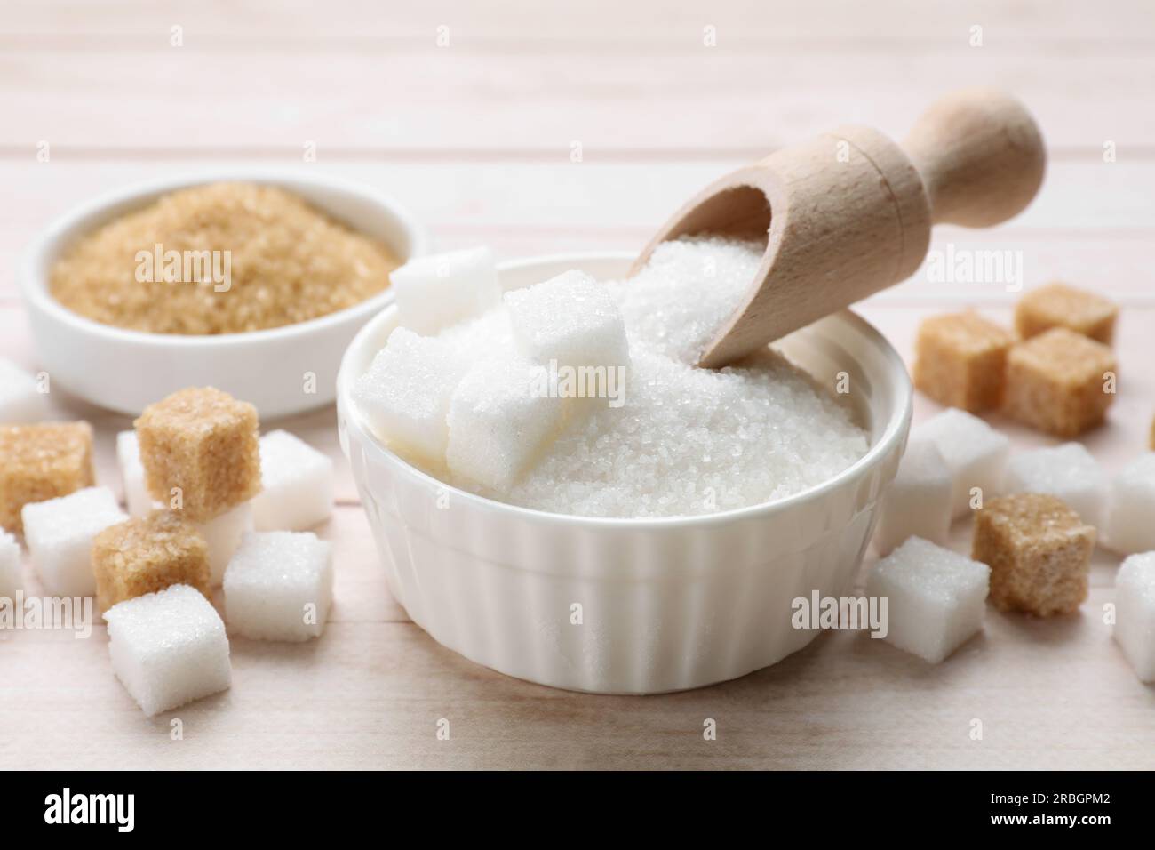 Different types of sugar on white wooden table, closeup Stock Photo - Alamy