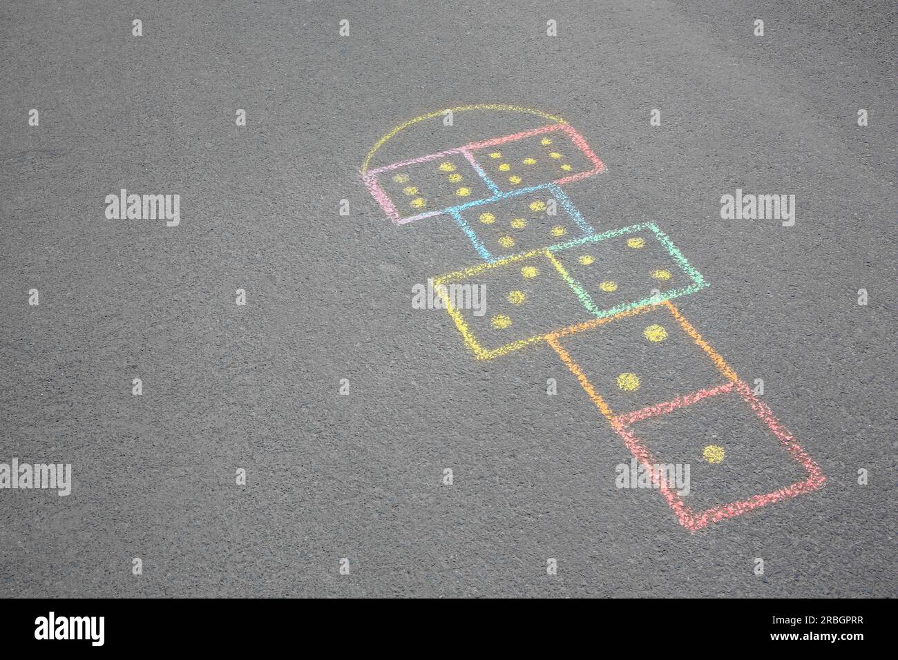 Hopscotch drawn with colorful chalk on asphalt outdoors. Space for text ...