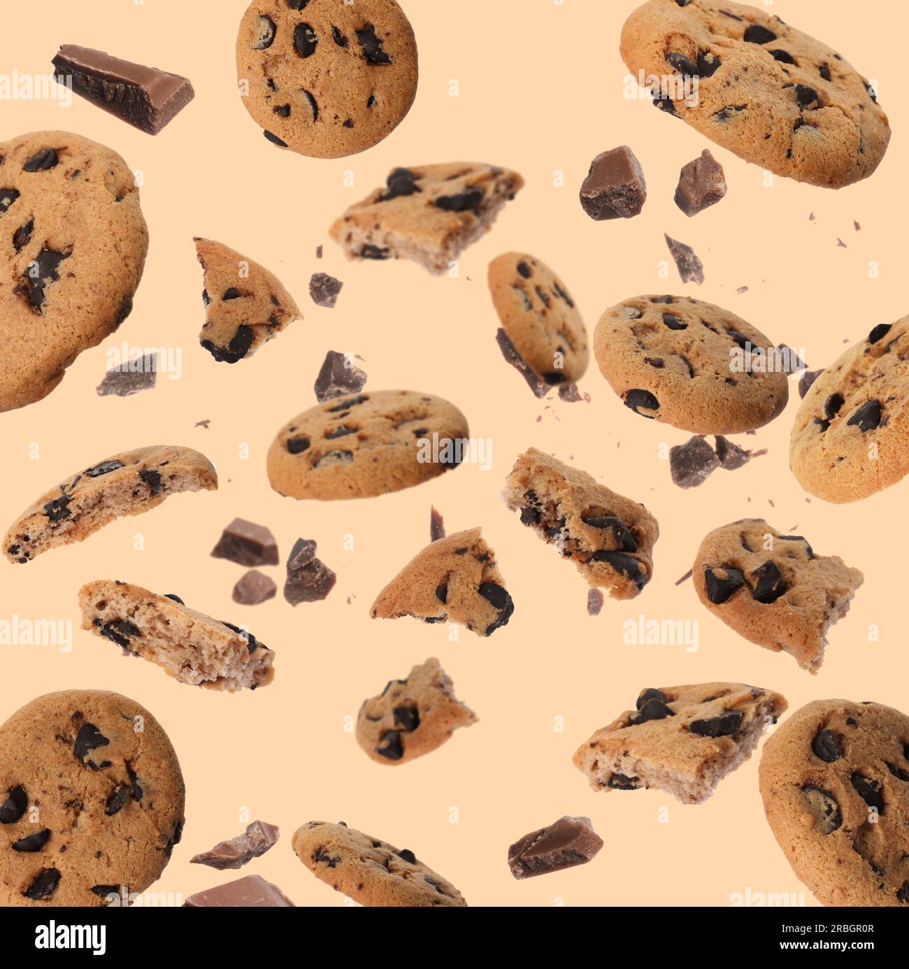 Delicious chocolate chip cookies and pieces of chocolate falling on ...