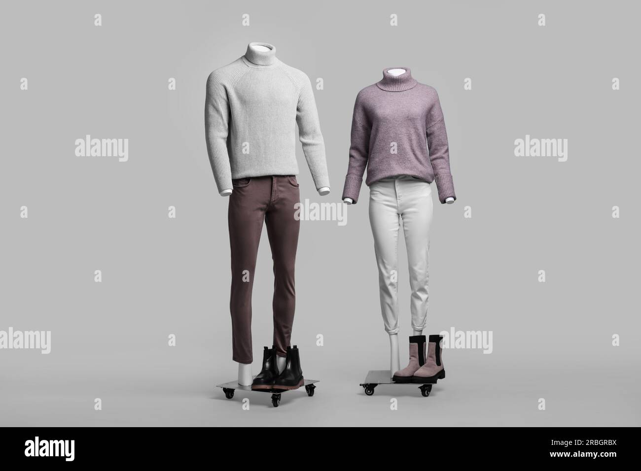 Male and female mannequins dressed in stylish outfits on grey ...