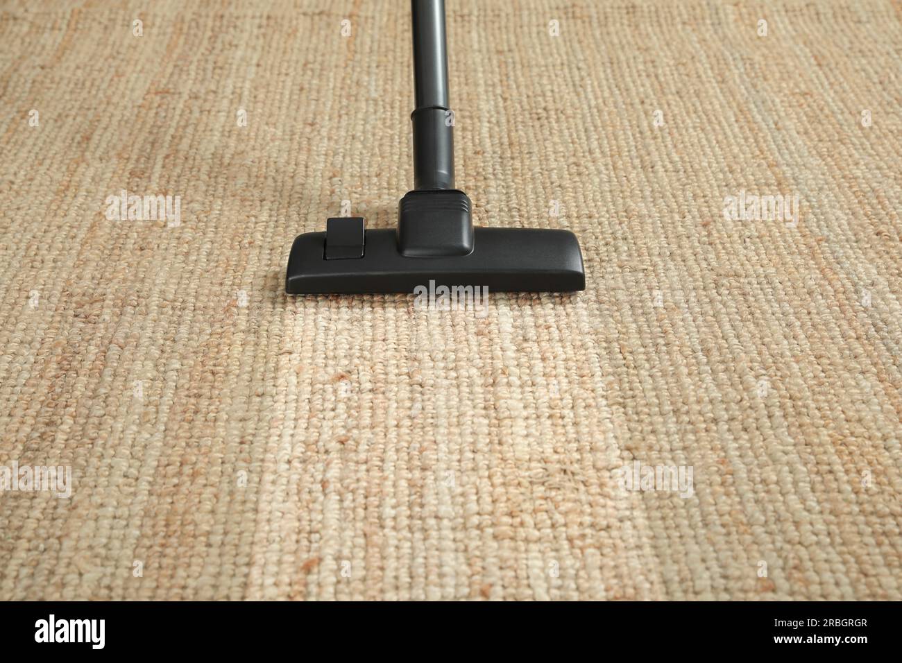 Hoovering carpet with vacuum cleaner. Clean trace on dirty surface ...