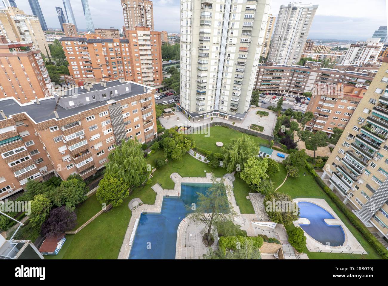 Common landscaped areas with several swimming pools, lots of grass and ...