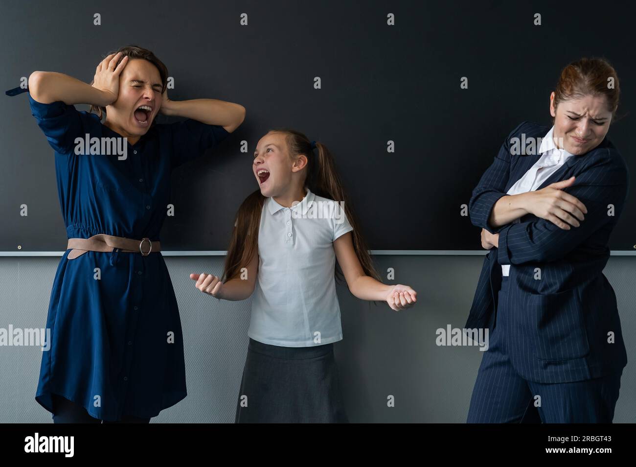 Schoolgirl and her mother yell at the teacher standing at the ...