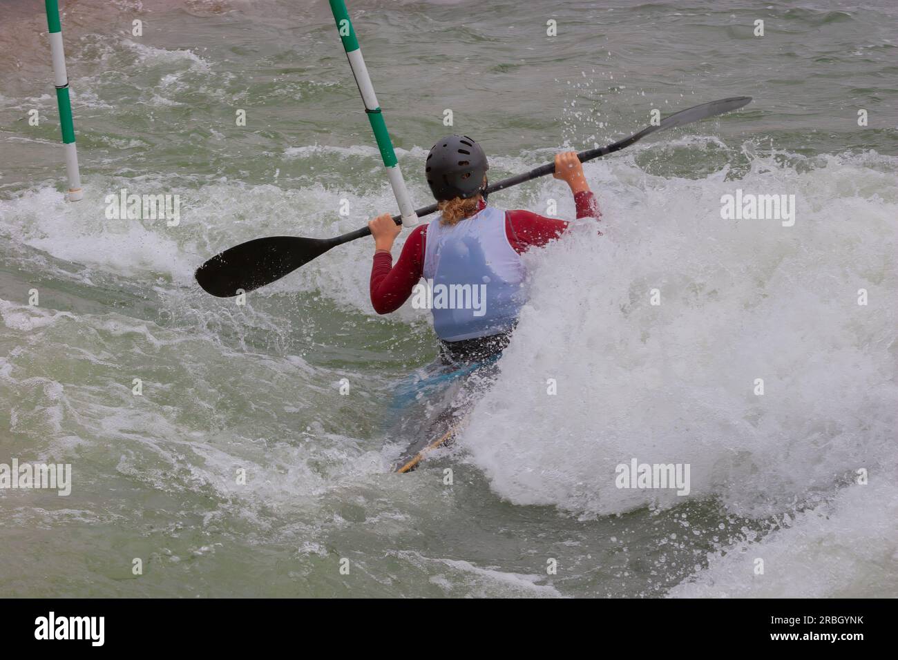 A canoeist paddling through fast running white water Stock Photo - Alamy