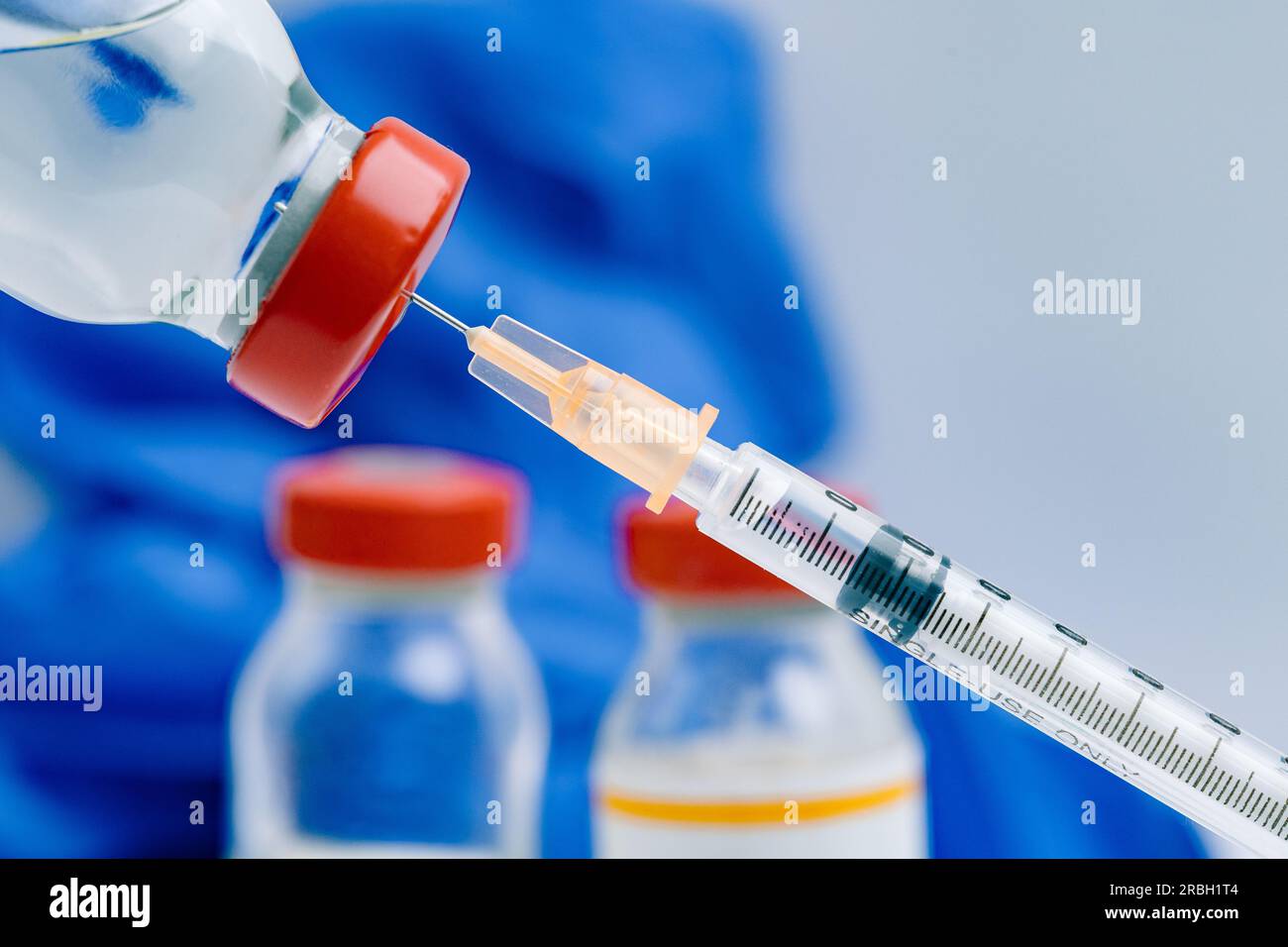 vaccine and vaccination concept 24 gauge syringe with red top vial ...