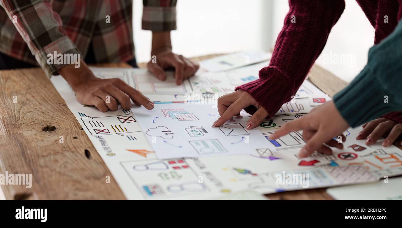 Close up ux developer and ui designer brainstorming interface wireframe ...