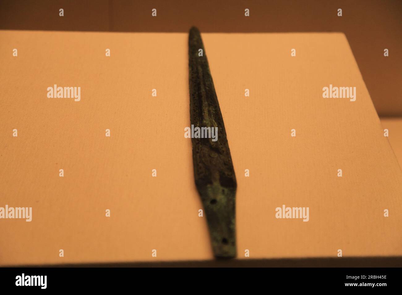 HAMI, CHINA - JUNE 11, 2023 - A bronze sword with a pattern of Warring ...