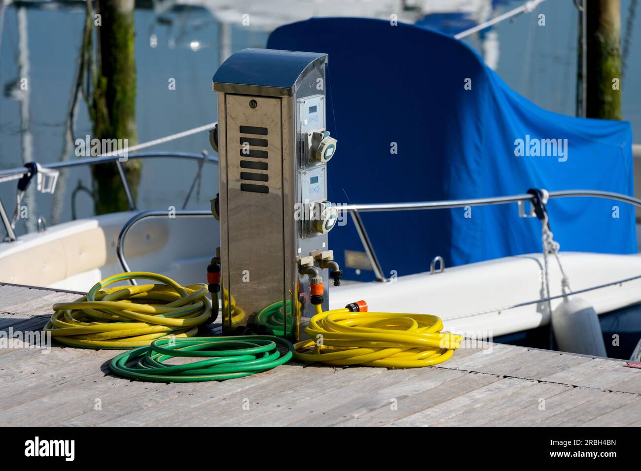 Power and water supply for ships moored in the port with water hoses ...