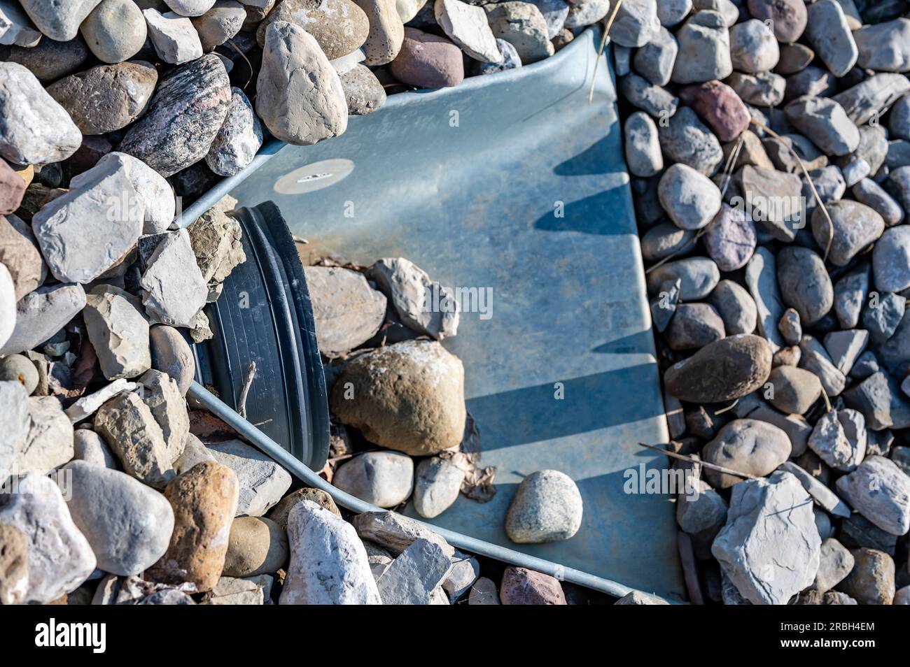 underground drainage storm drain with winged walls surrounded by rock ...
