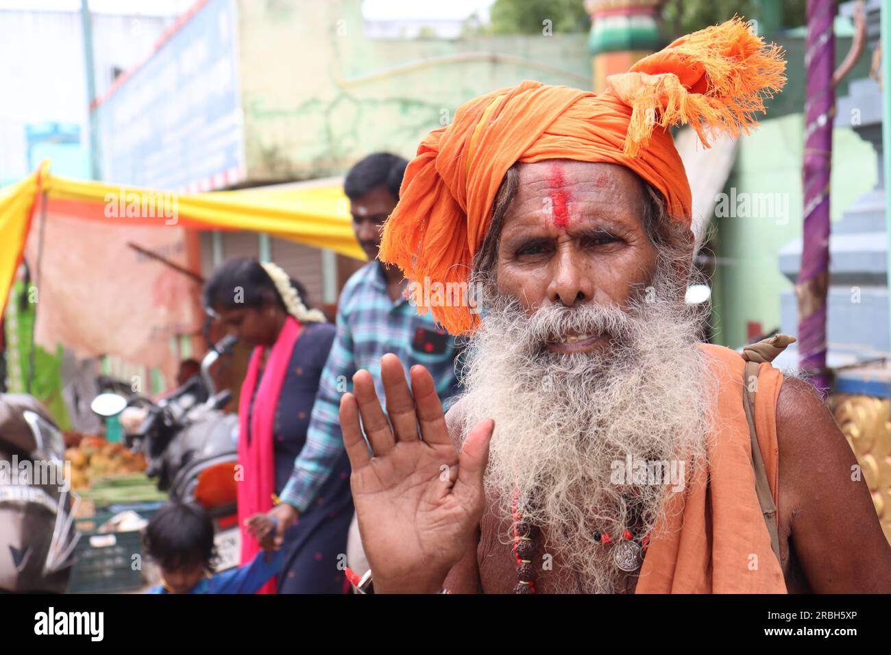 A tractor is on work. A baba is showing his hands like praising the ...