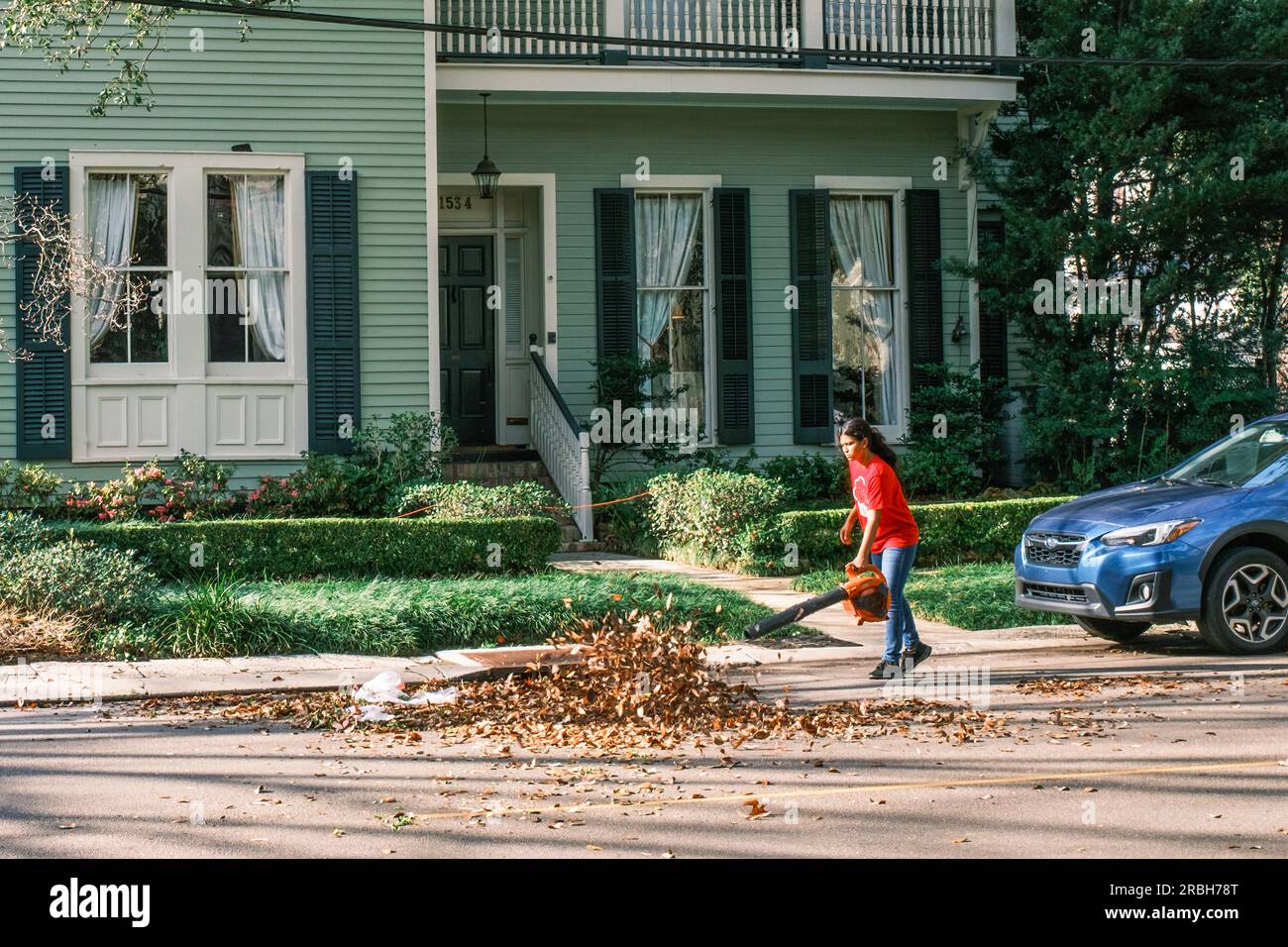 Woman leaf blower blow leaves hi-res stock photography and images - Alamy