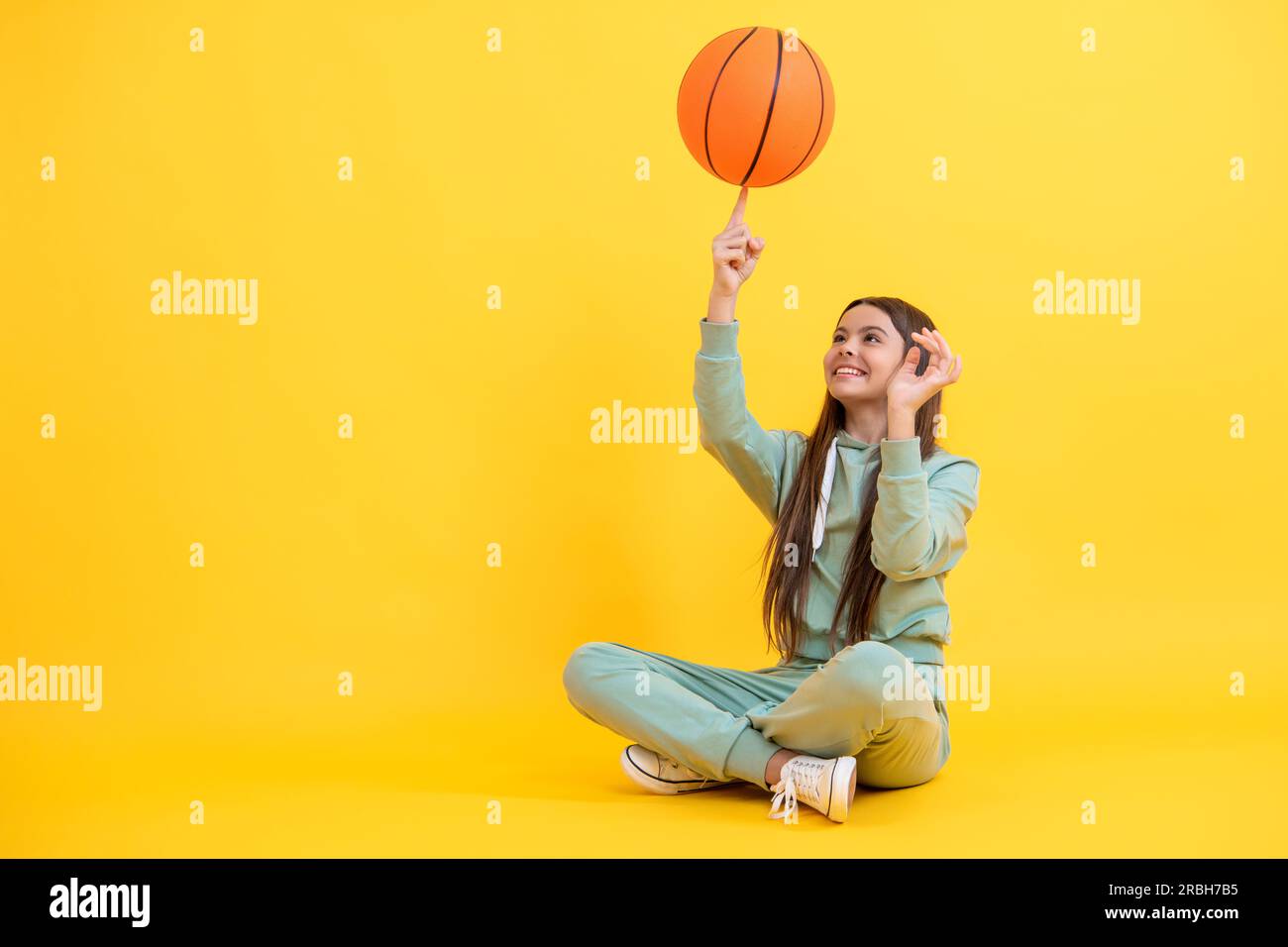 Teen girl excelling in basketball. Skilled teen girl playing the ...