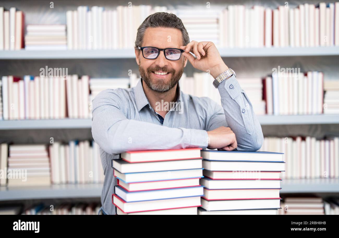 university teacher professor in school classroom library preparing for ...
