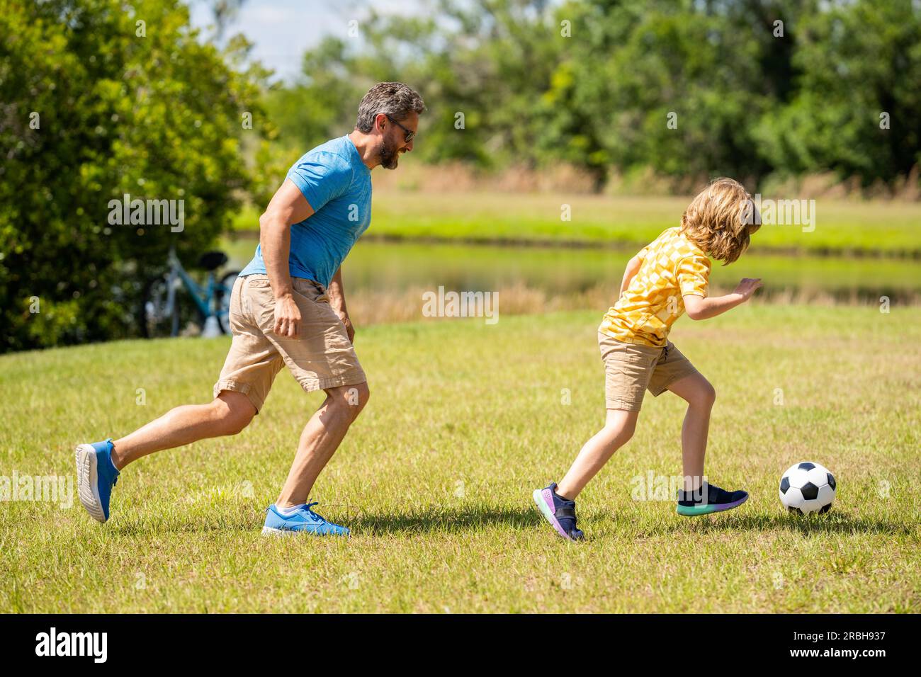 adventures between father and son. Active father son playing football ...