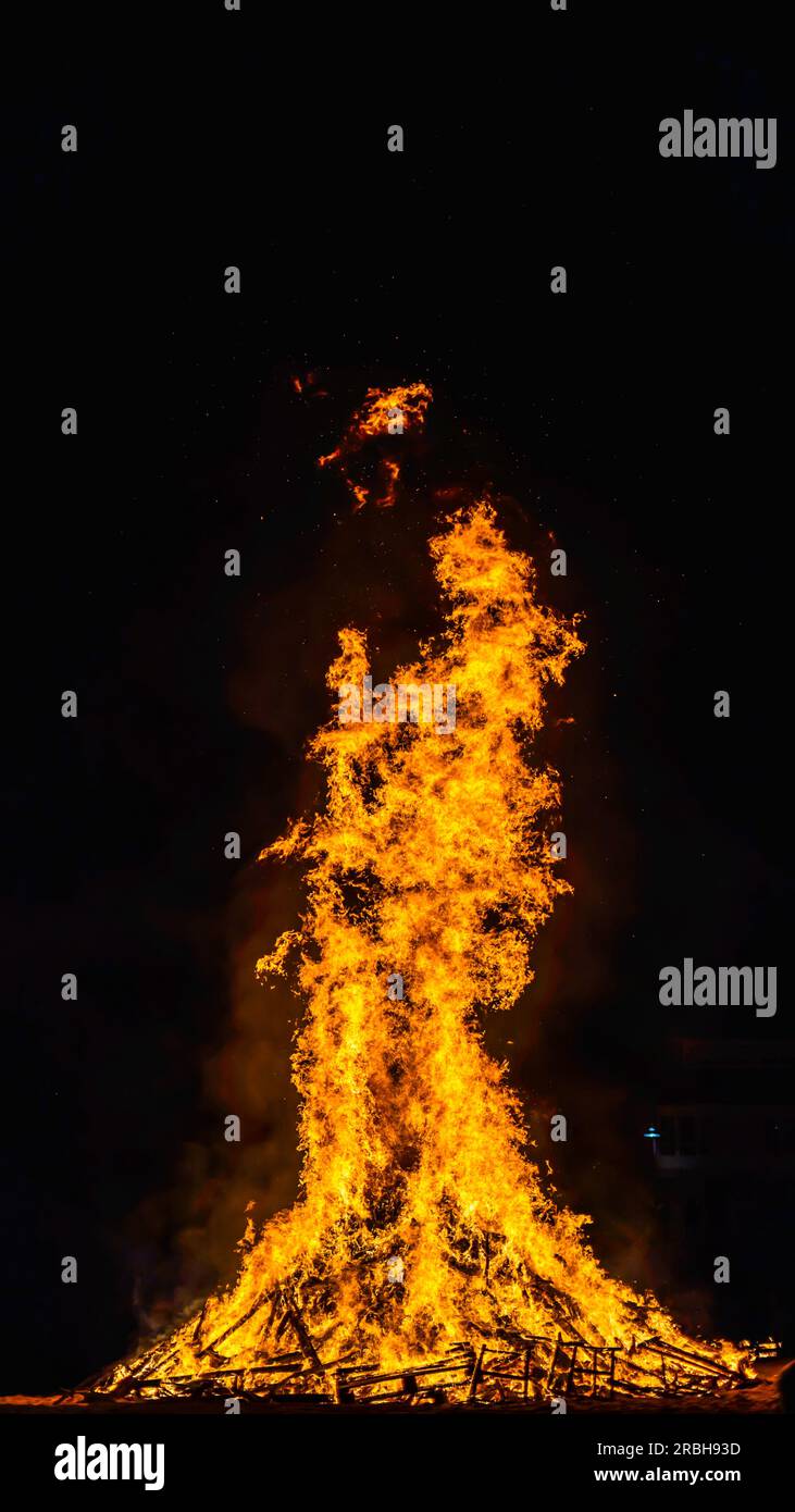 tower of flames on a huge bonfire at night in vertical Stock Photo - Alamy