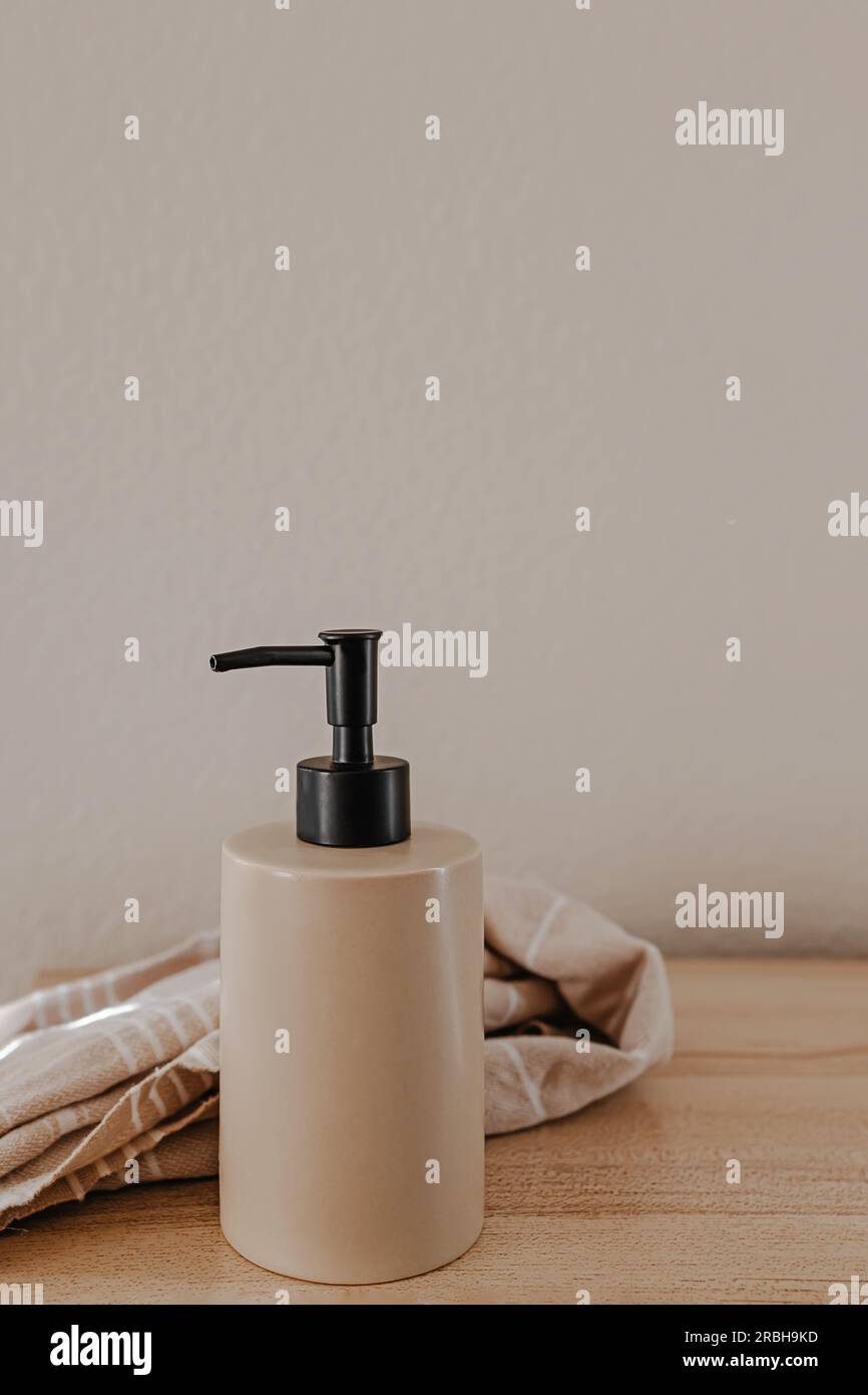 Stone soap dispenser and hand towel, beige colors Stock Photo - Alamy