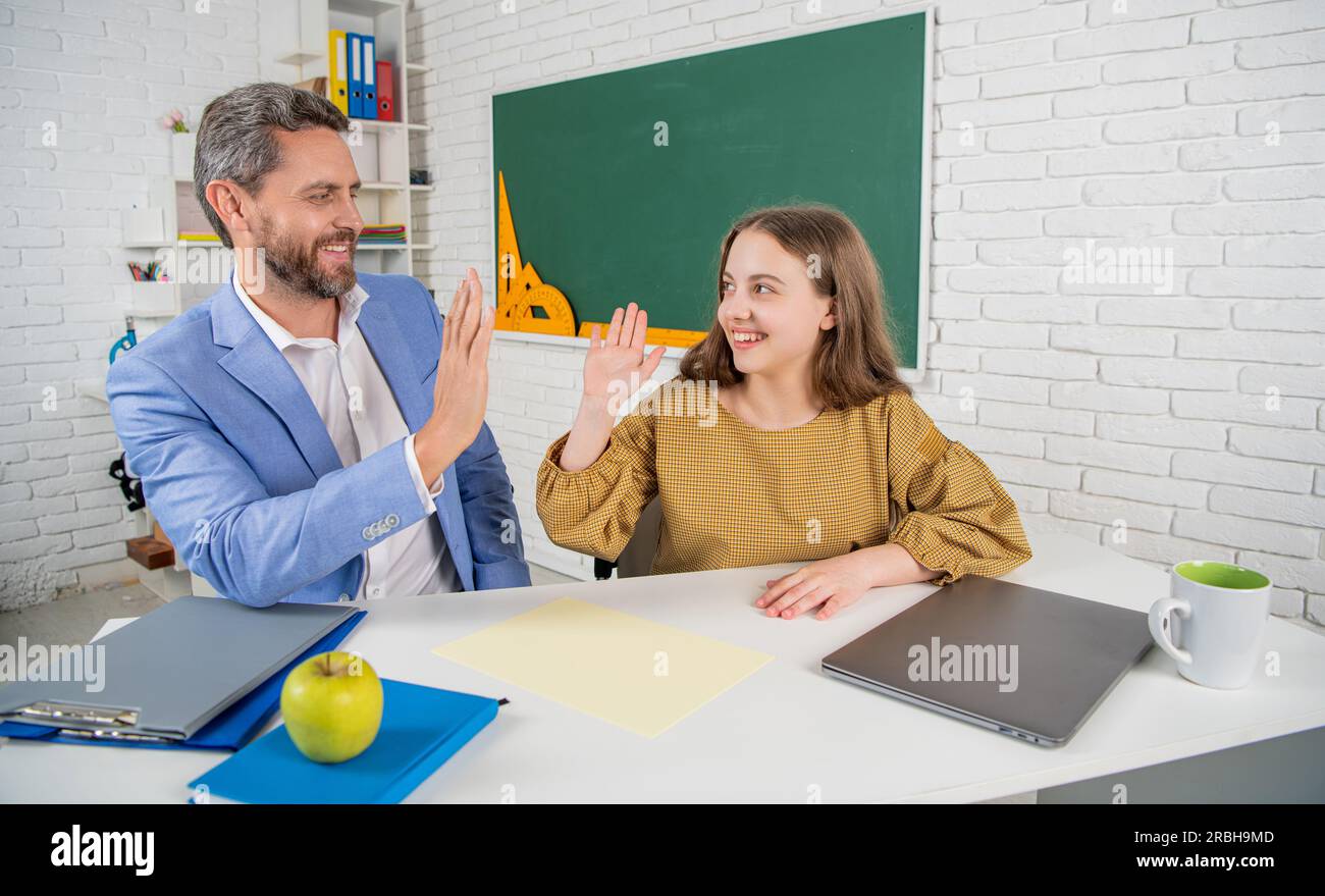 glad child study in classroom with tutor Stock Photo - Alamy