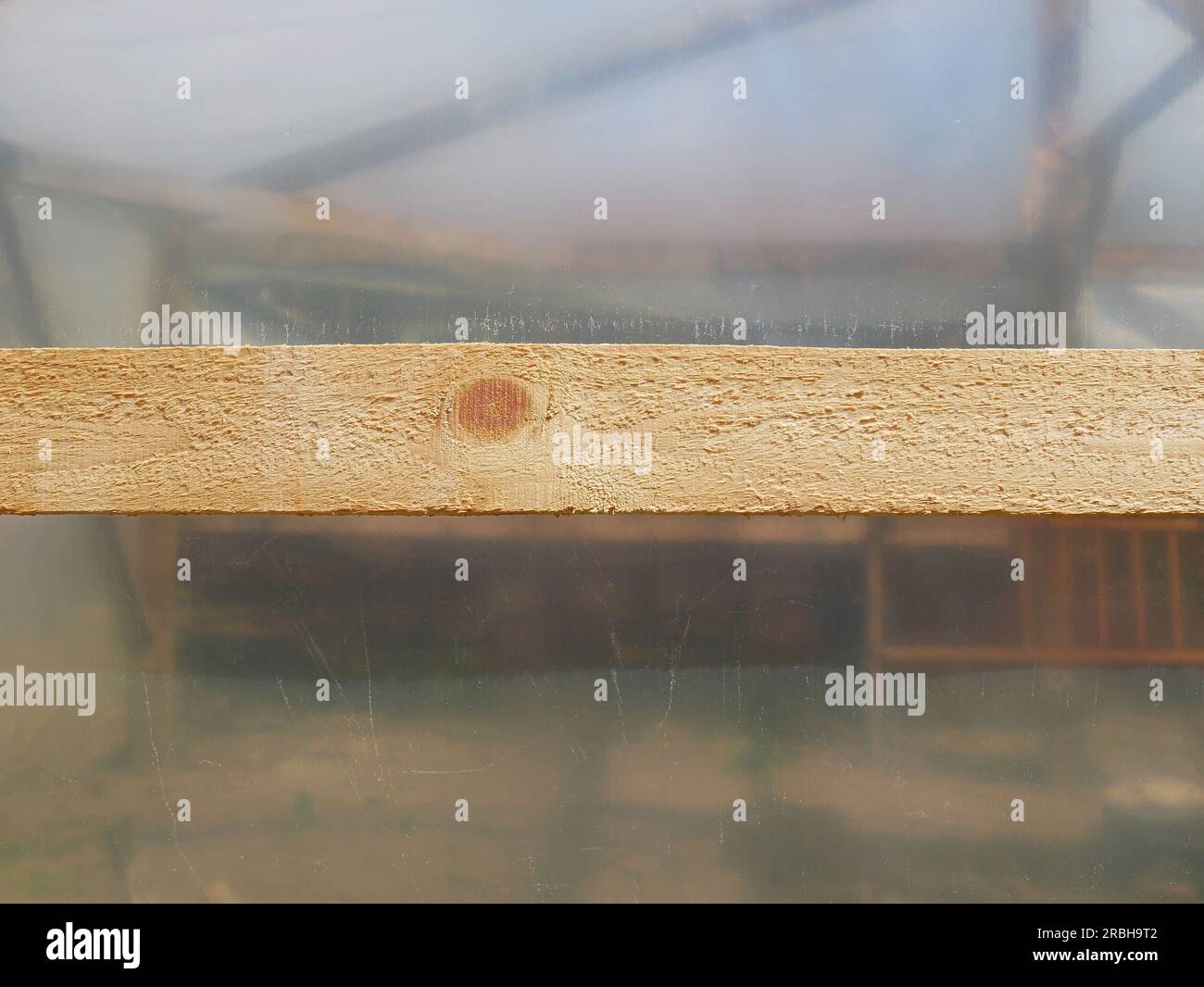 Horizontal single long narrow wooden plank with a knot on the ...