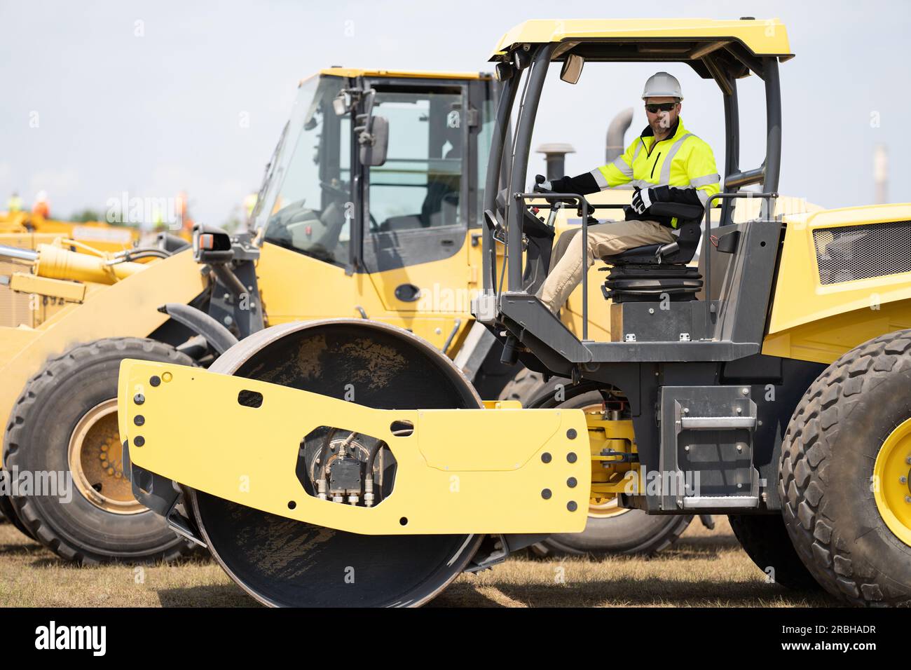 construction worker man used heavy machinery road roller equipment on building industry site for ...