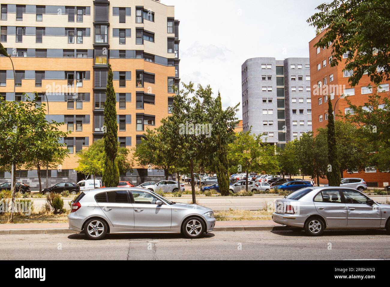 City street Cars parked on a road Multistory buildings Residential ...