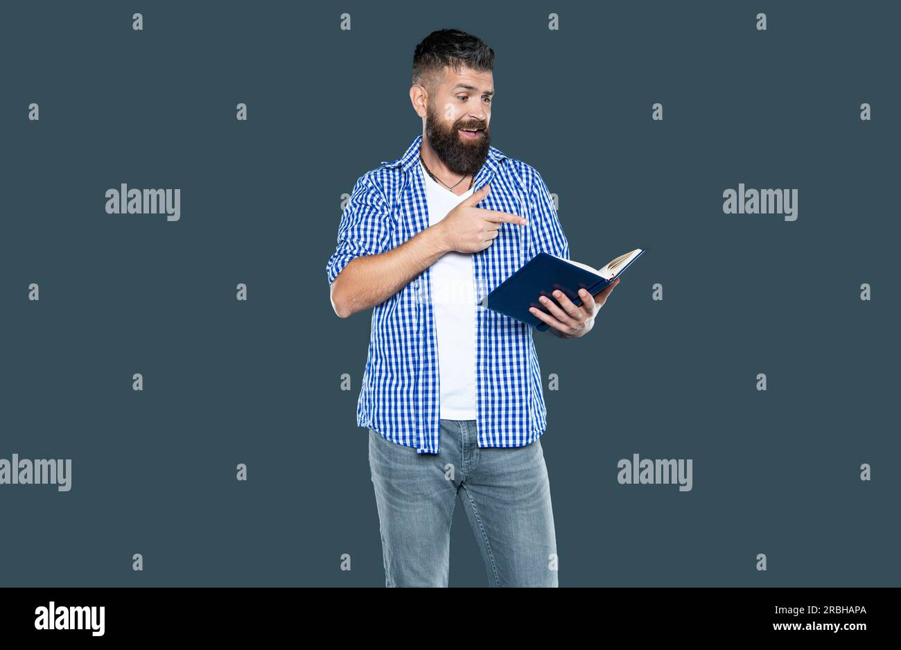 confused bearded man pointing finger on book on grey background Stock ...
