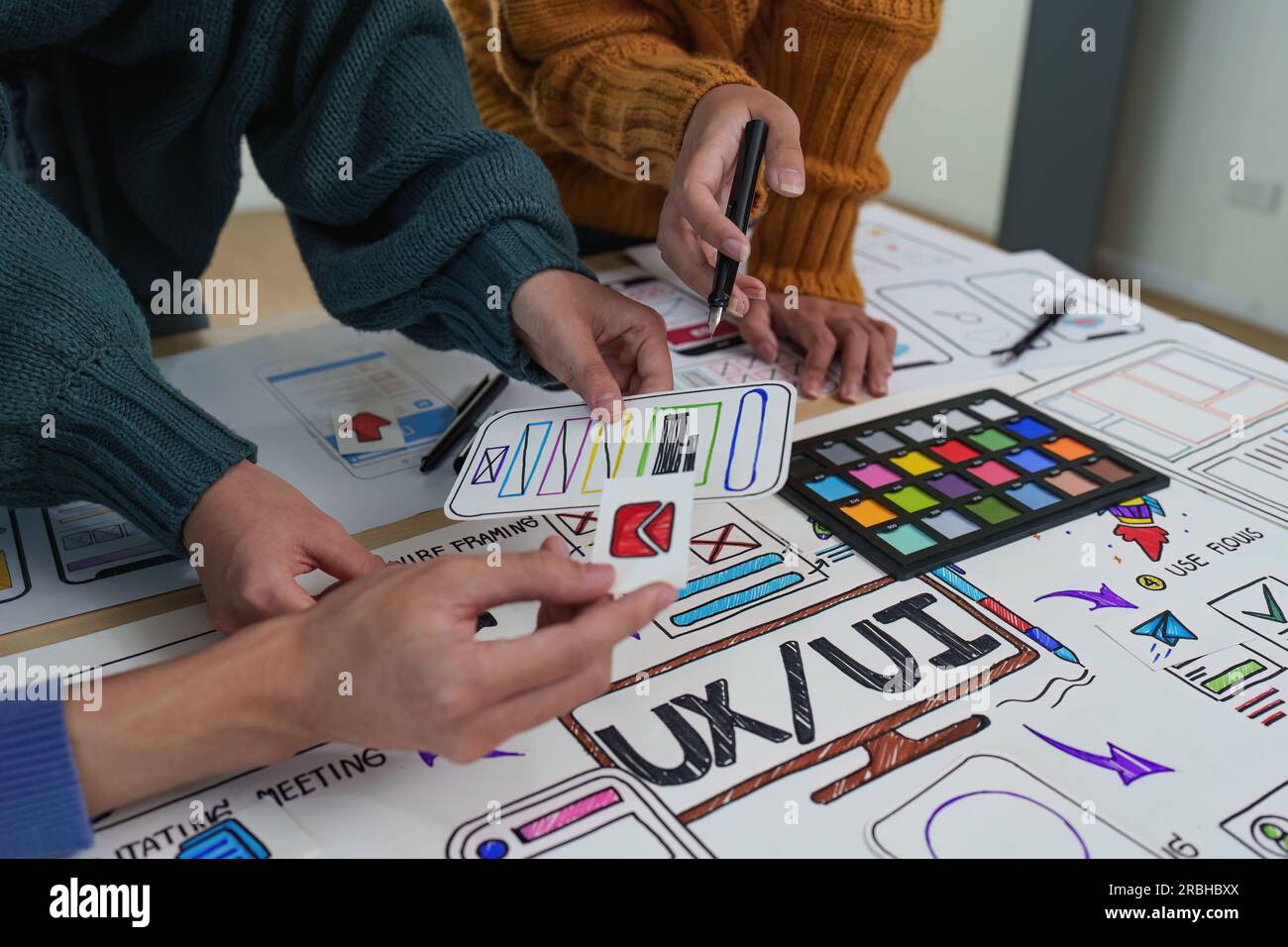 Close up ux developer and ui designer brainstorming interface wireframe ...