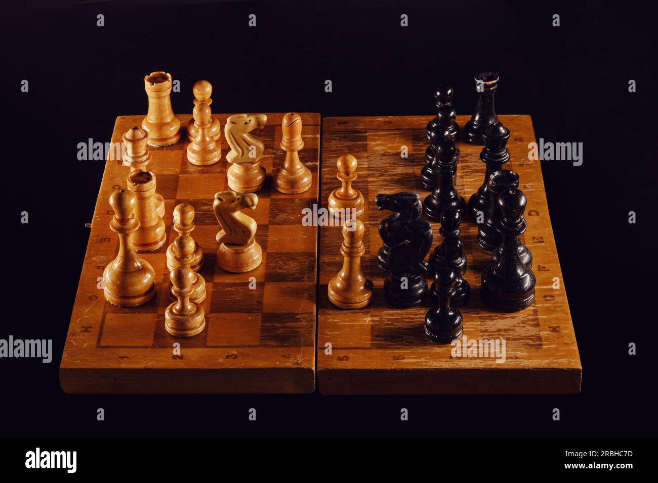 Playing with old chess pieces in the middlegame. Chess board with retro ...
