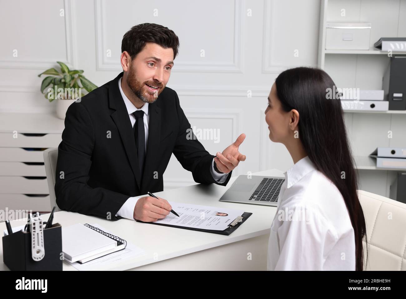Human resources manager conducting job interview with applicant in office Stock Photo - Alamy