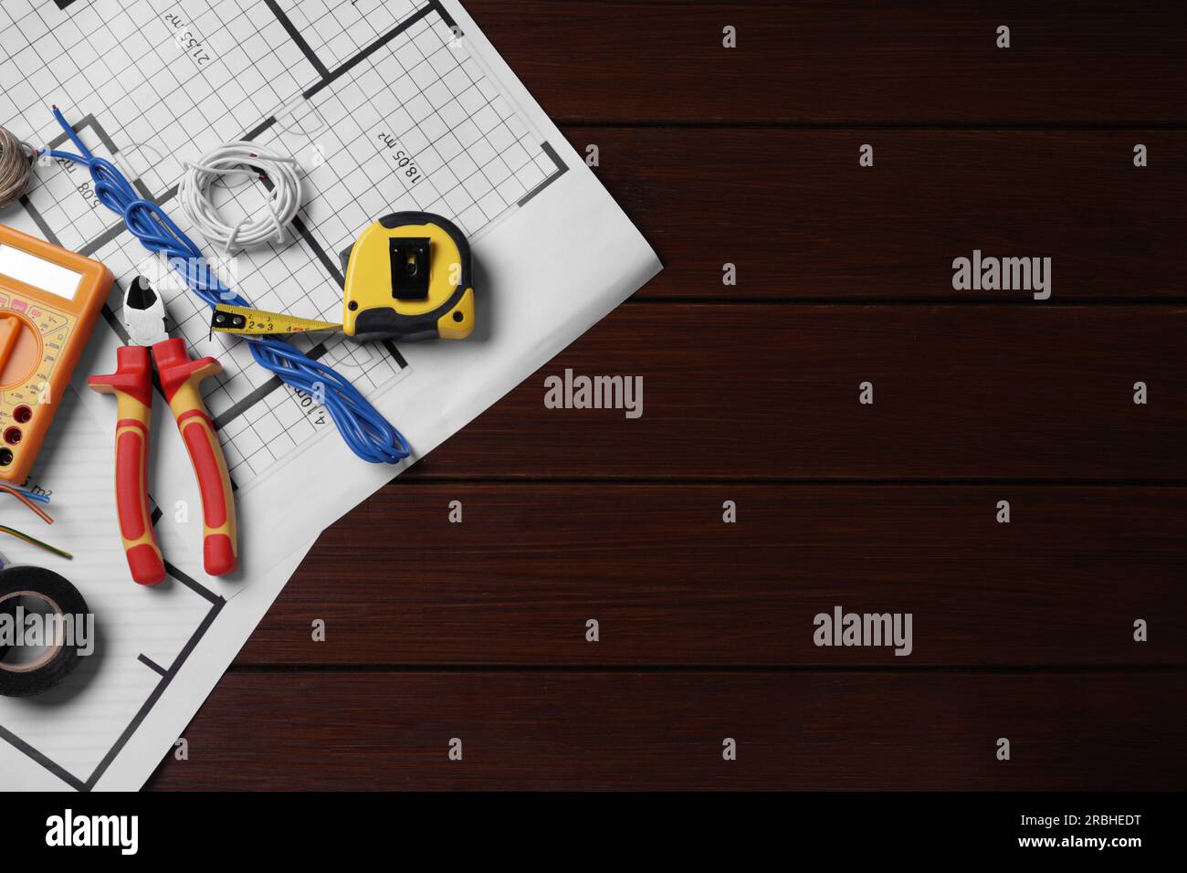 Different wires and electrician's tools on wooden table, top view ...