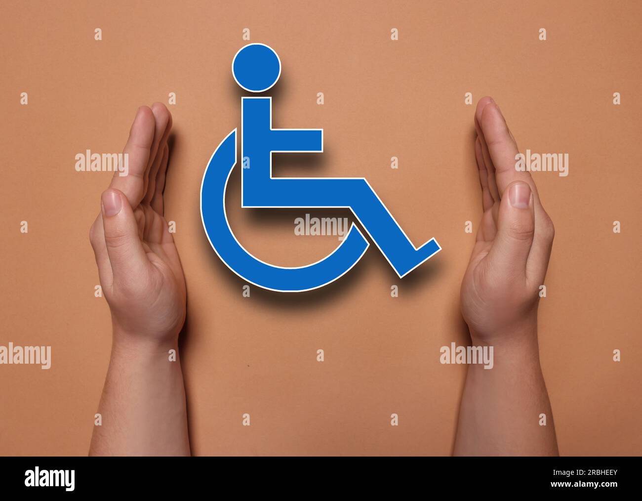 Disability inclusion. Woman protecting wheelchair symbol on coral ...