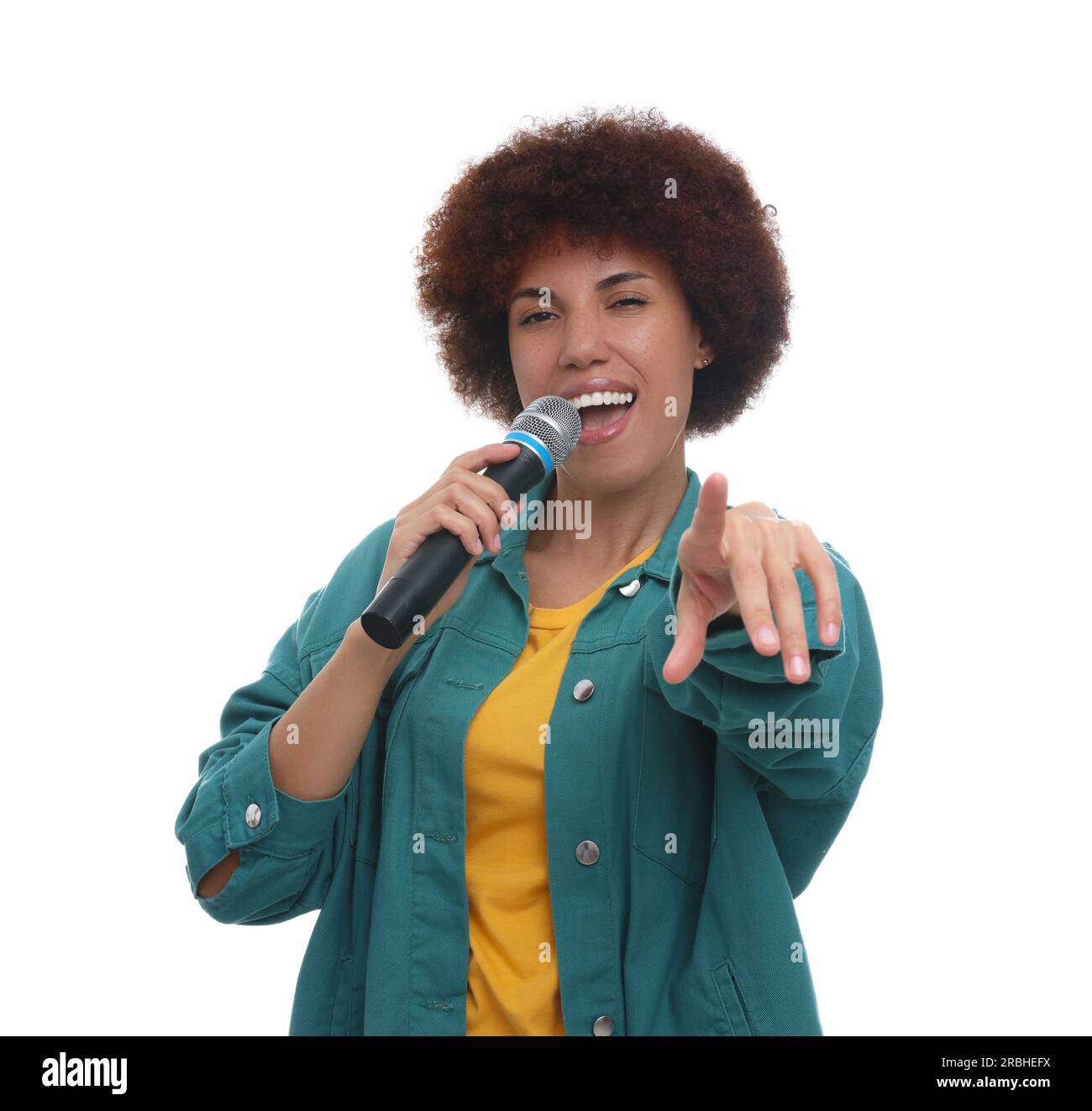 Curly young woman with microphone singing on white background Stock ...