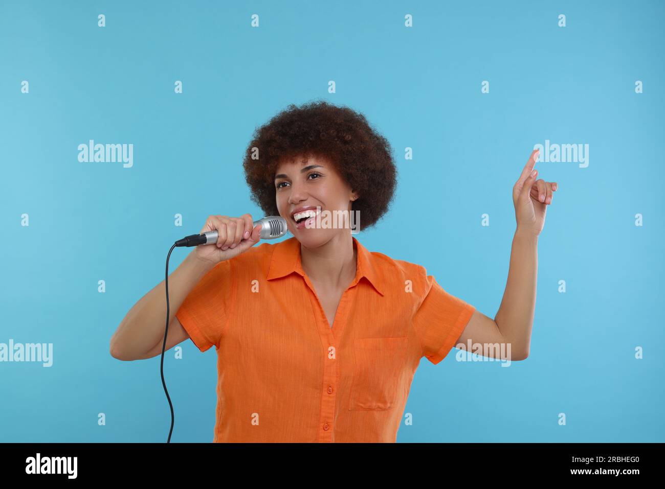 Woman pointing singing microphone hi-res stock photography and images ...