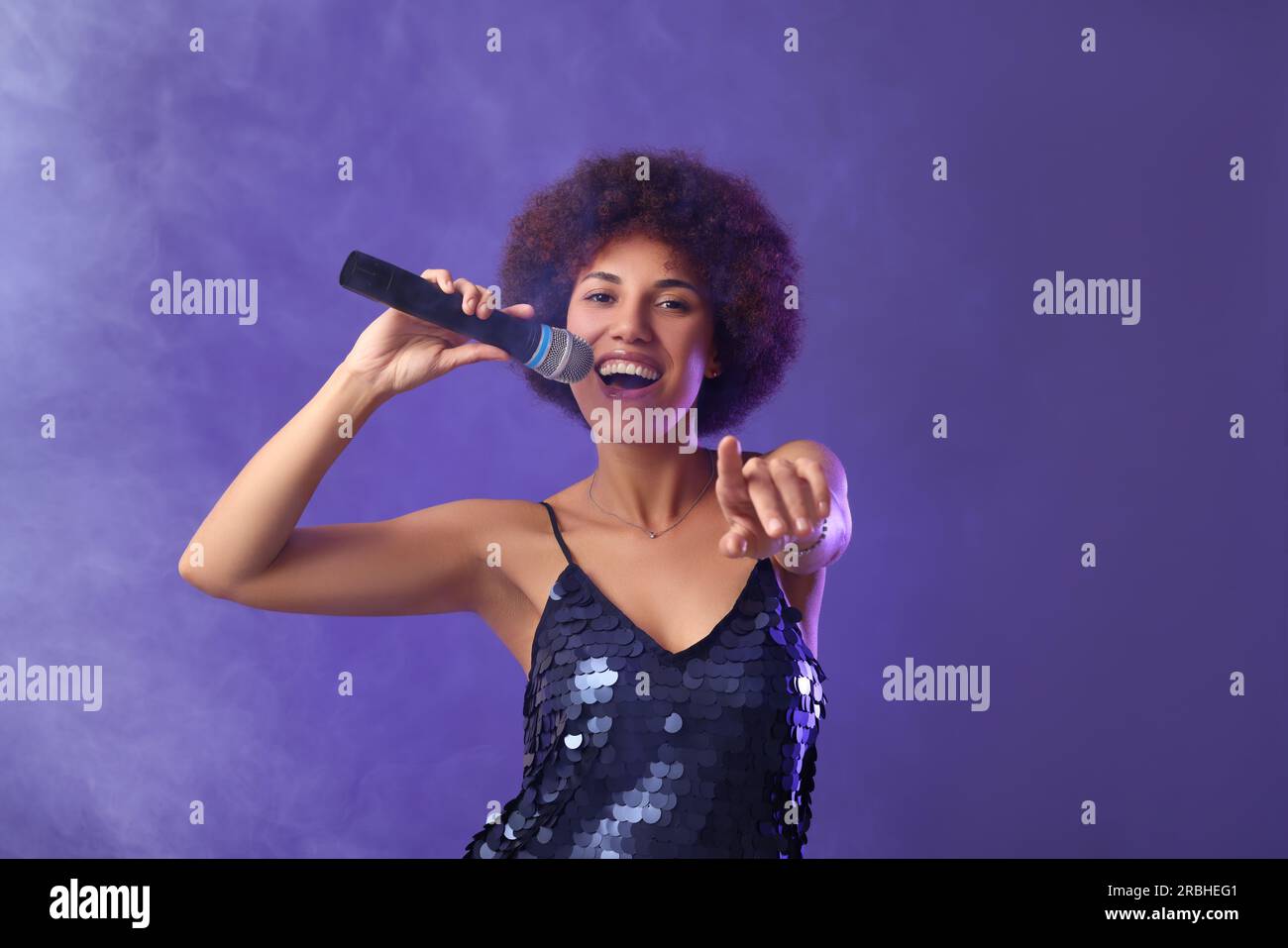 Woman pointing singing microphone hi-res stock photography and images ...