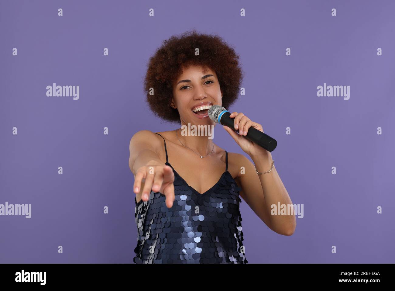Woman pointing singing microphone hi-res stock photography and images ...