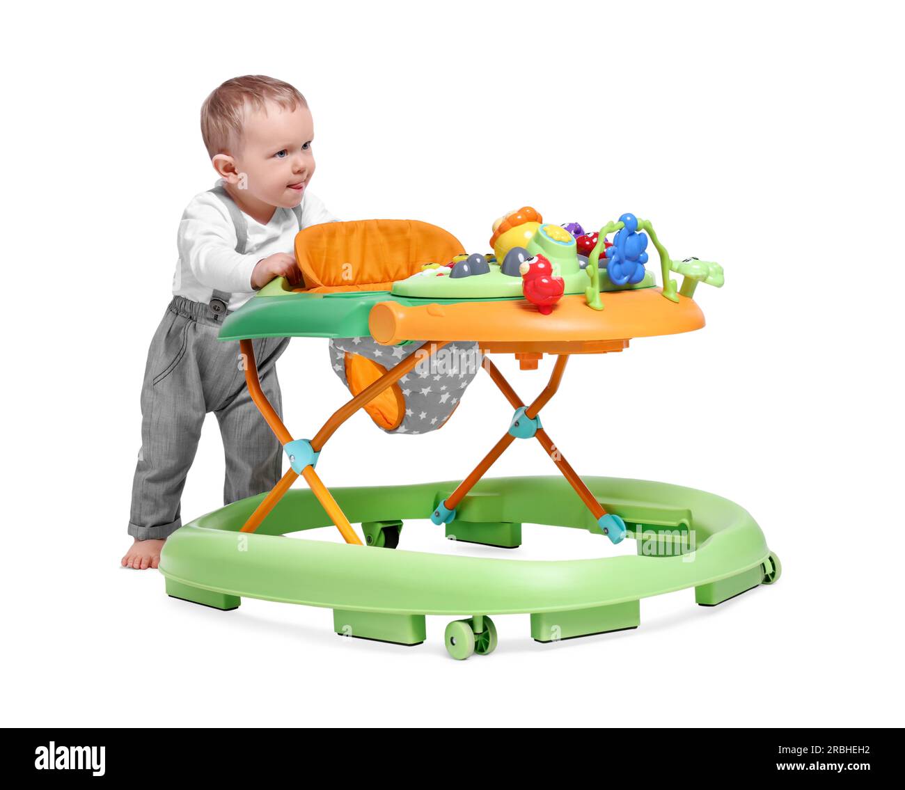 Cute little boy with baby walker on white background Stock Photo - Alamy