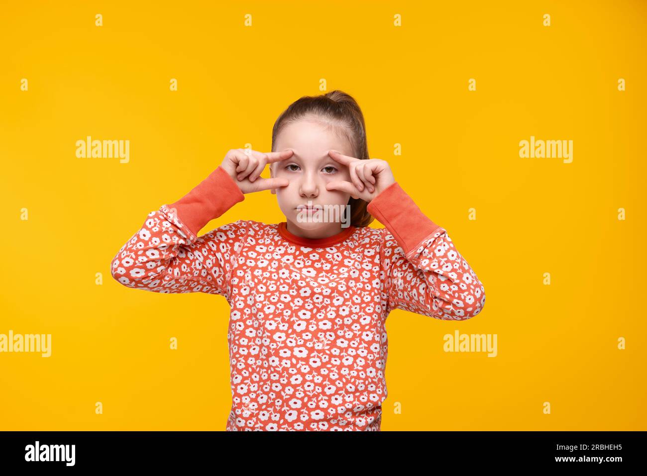 Sleepy girl on orange background. Insomnia problem Stock Photo - Alamy