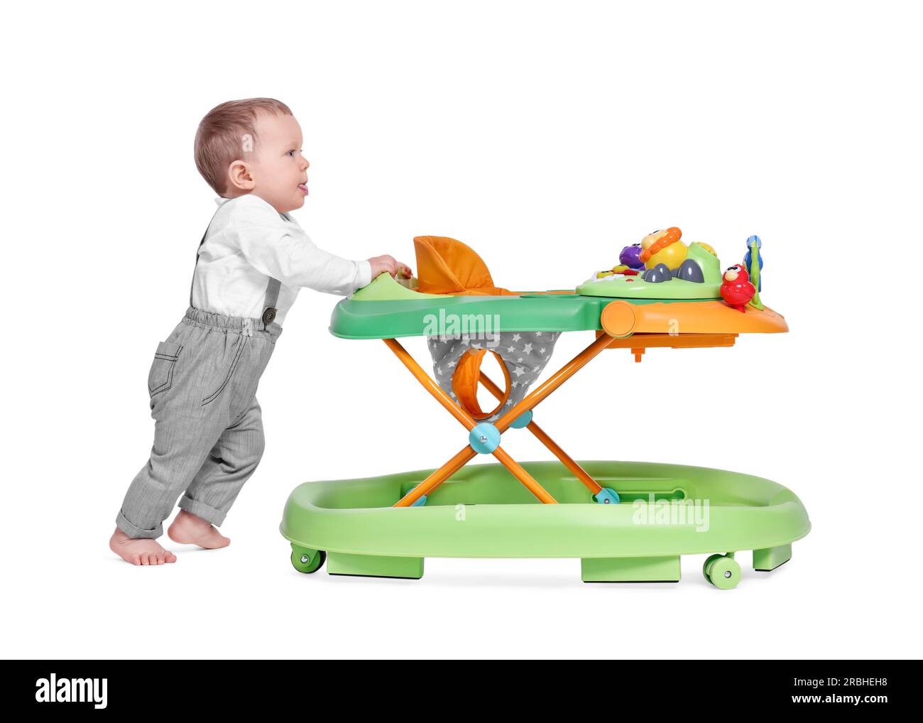 Cute little boy with baby walker on white background Stock Photo - Alamy