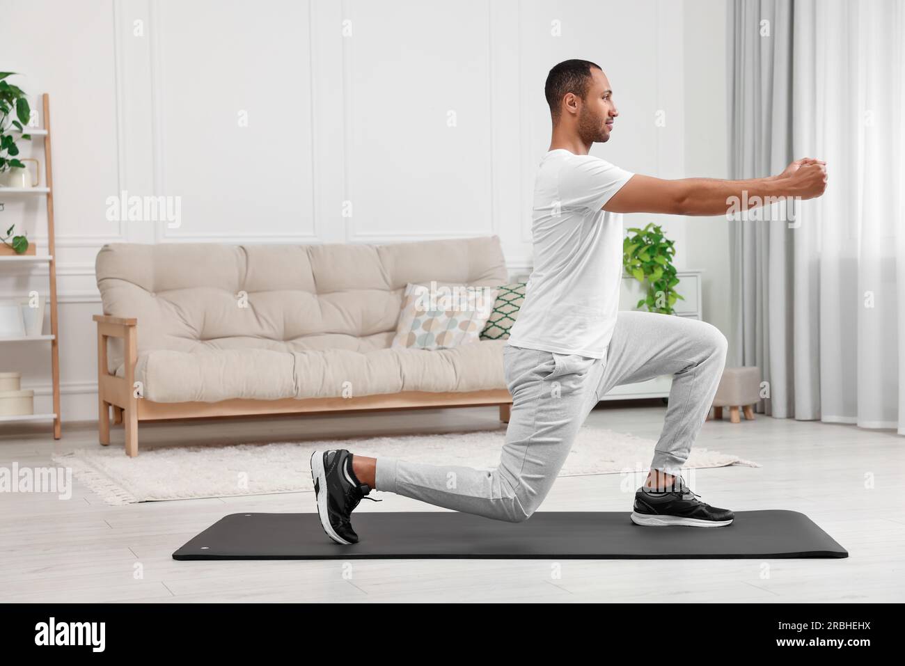 Man doing morning exercise on fitness mat at home Stock Photo - Alamy