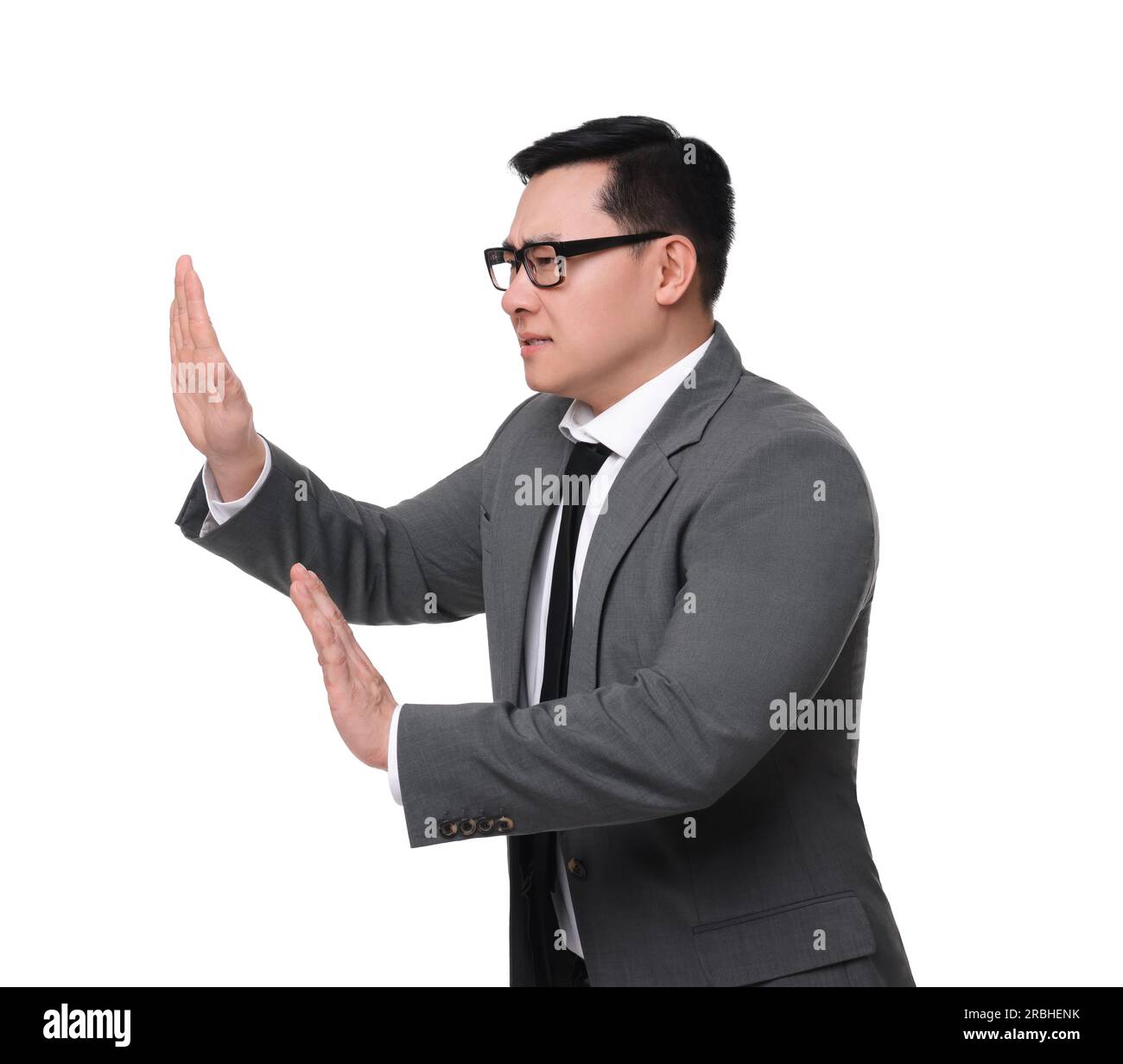 Scared businessman in suit posing on white background Stock Photo - Alamy