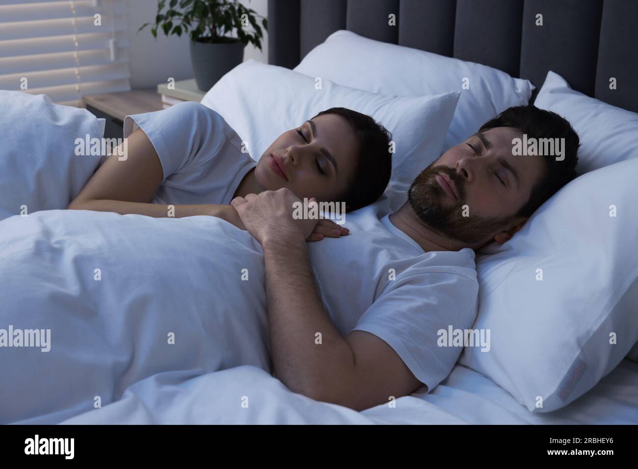 Sleeping together in bed at night hi-res stock photography and images ...