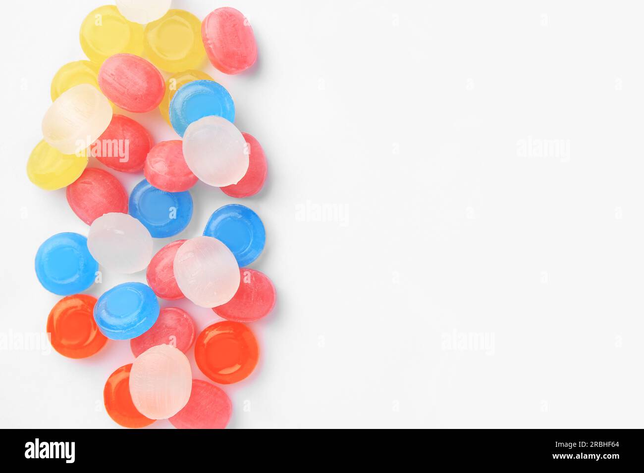 Many different colorful cough drops on white background, top view Stock ...