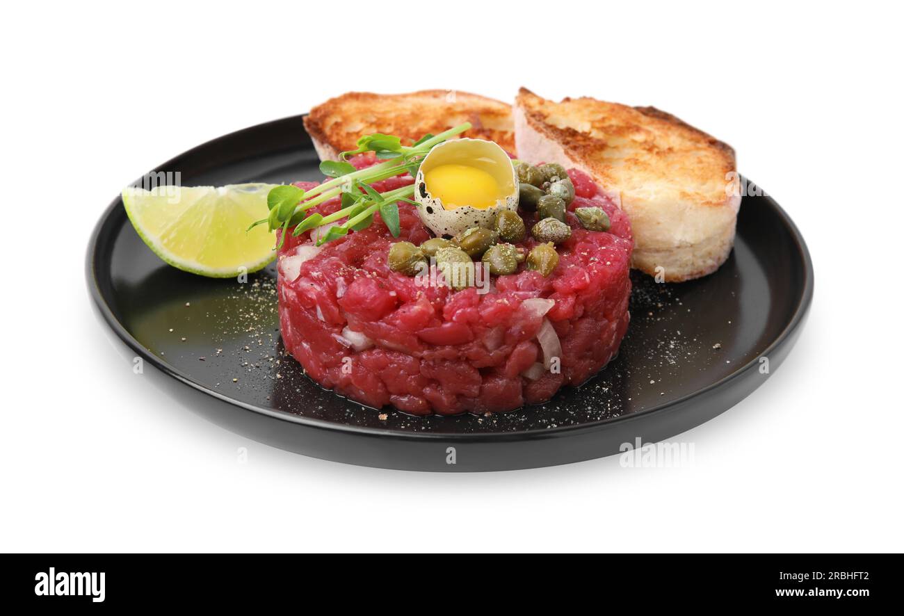 Tasty beef steak tartare served with quail egg, toasted bread and other ...