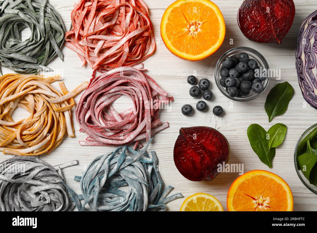 Rolled pasta painted with natural food colorings and ingredients on ...