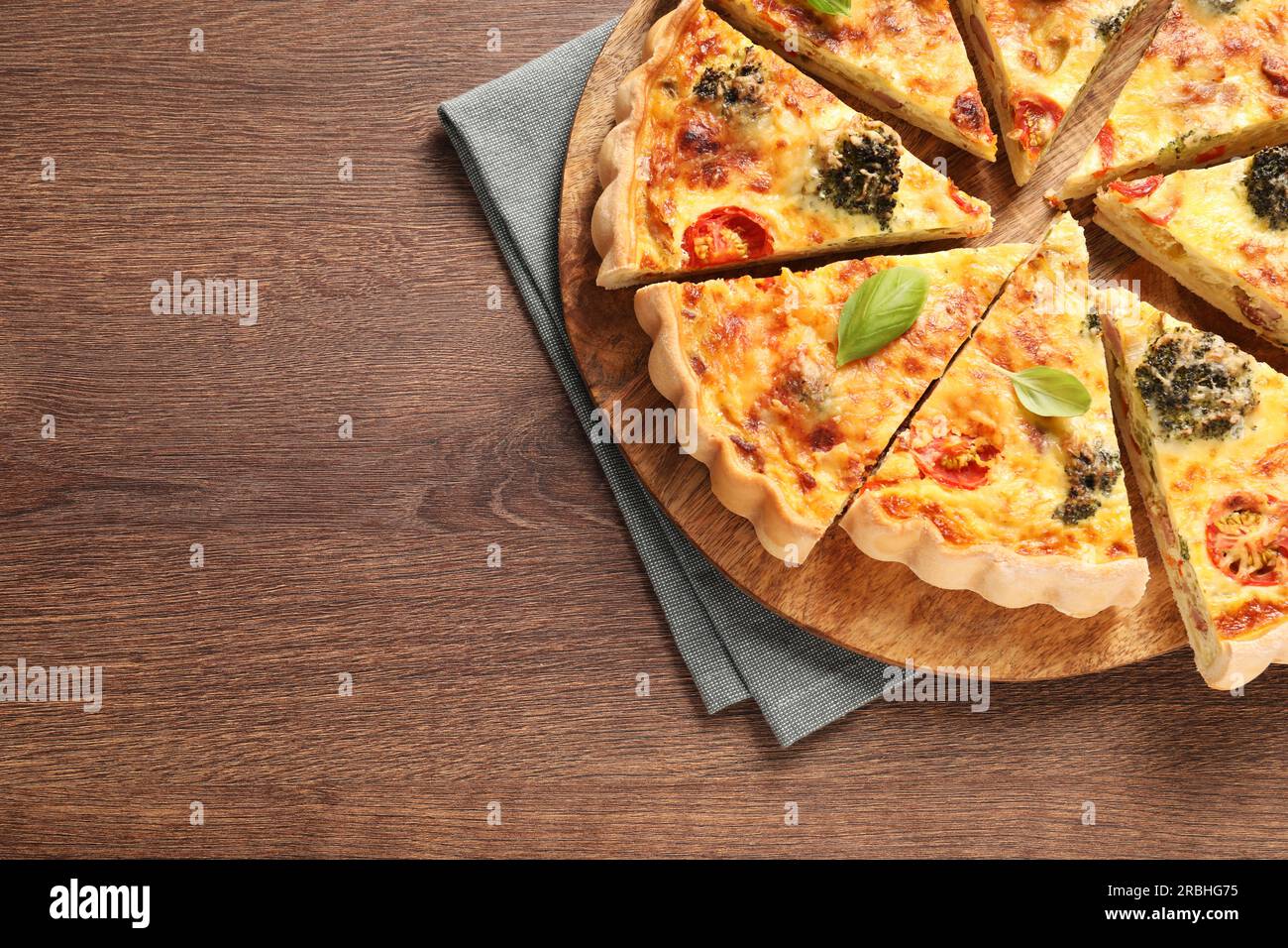 Delicious homemade vegetable quiche on wooden table, top view. Space ...