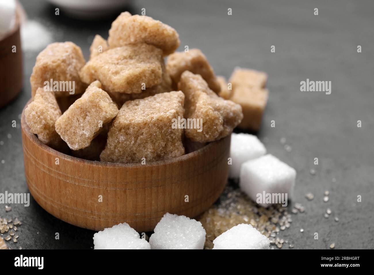 Different types of sugar on black table, closeup Stock Photo - Alamy