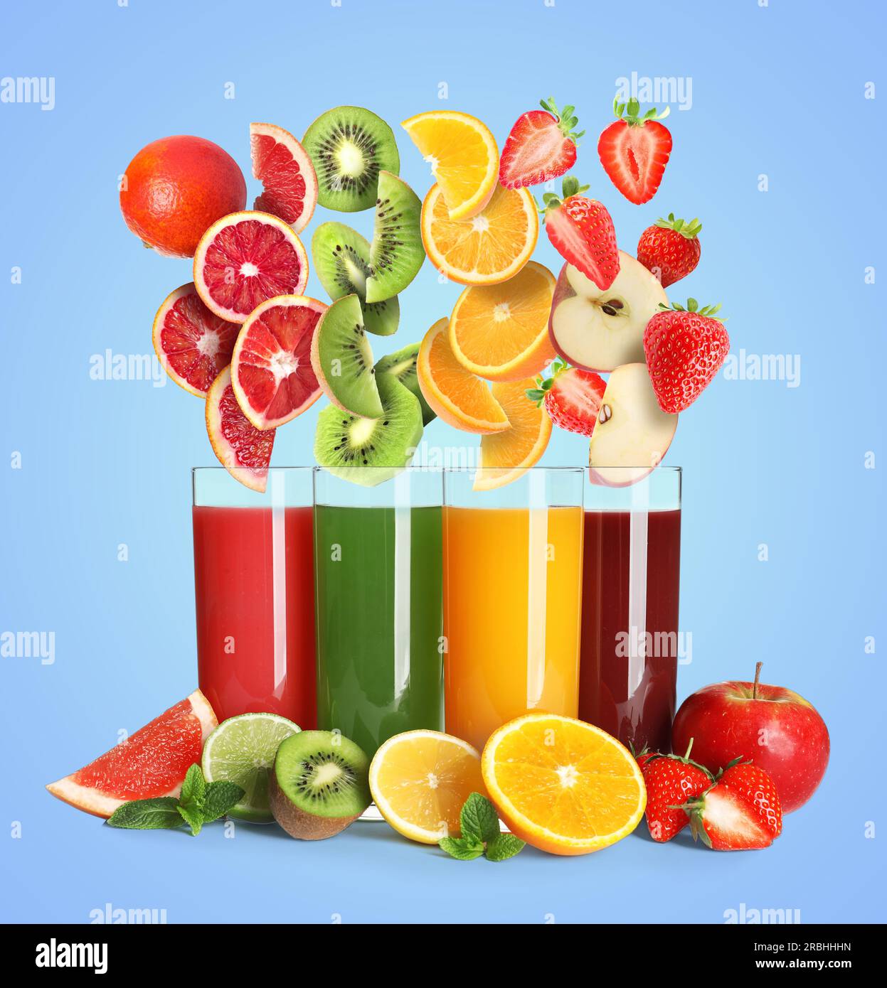 Different types of juices and fresh fruits on light blue background ...